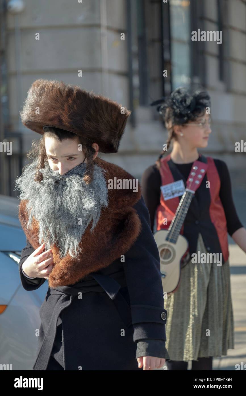 2 orthodox Jewish kids, presumably siblings, in their Purim costumes on ...