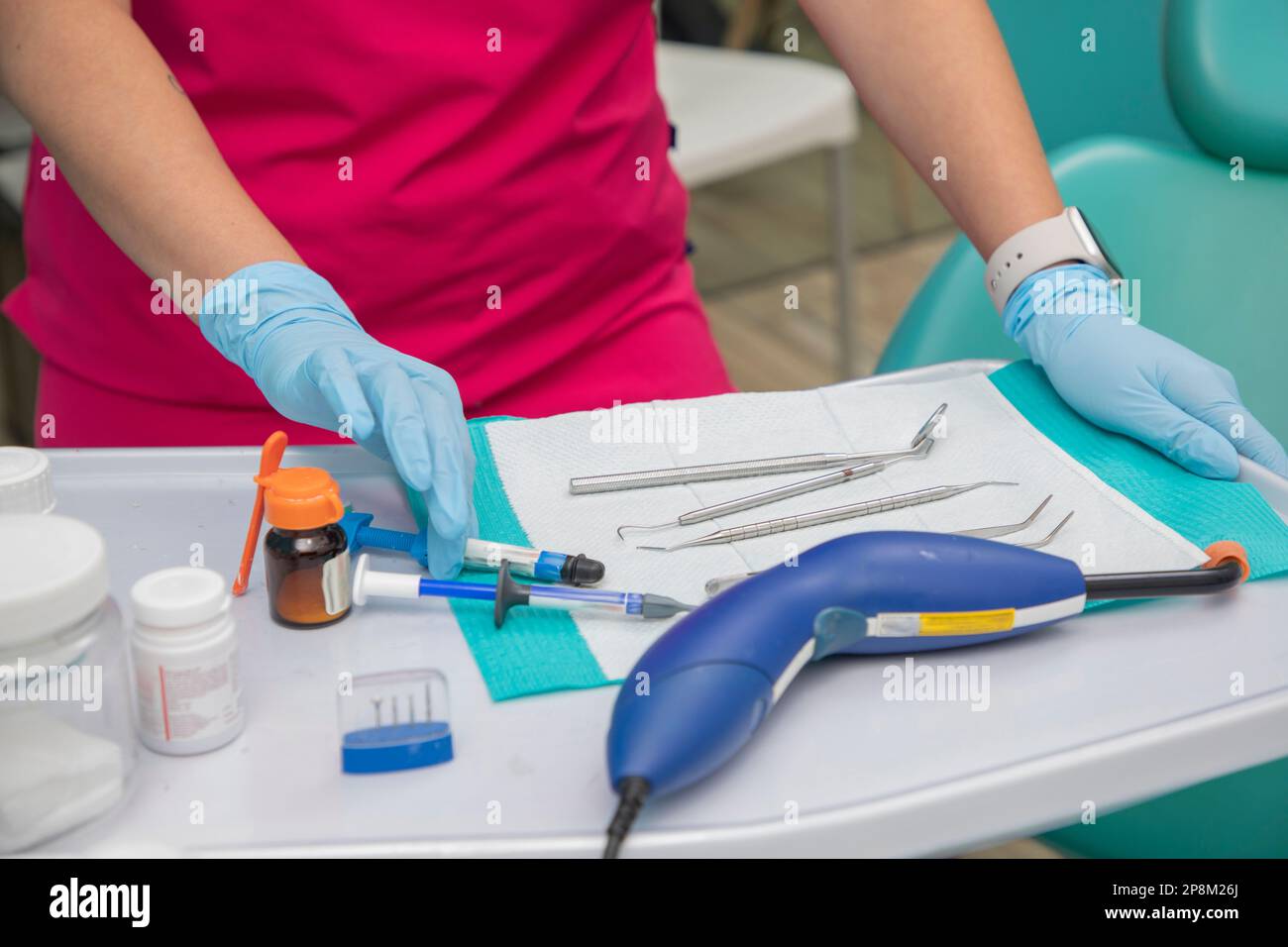 Close up of the hands of a dentist accommodating a set of dental ...