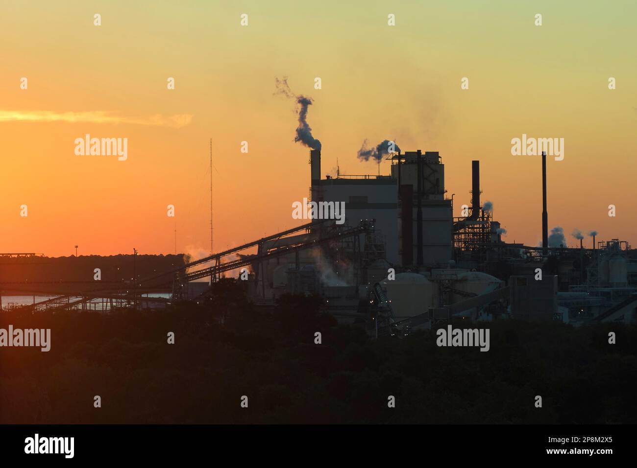 Aerial view of large factory with smokestack from production process ...
