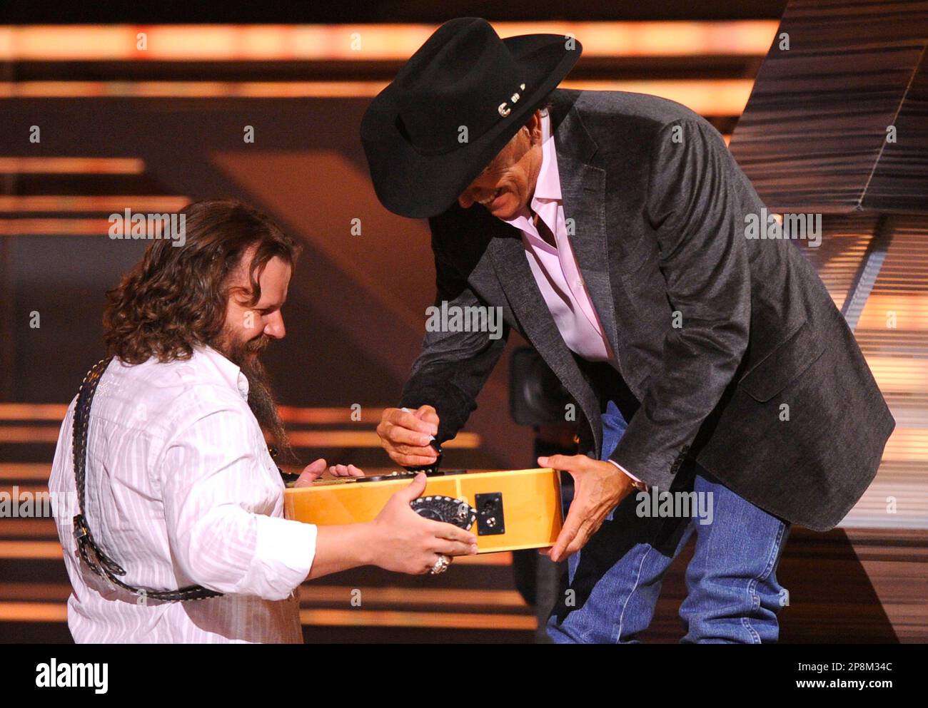 George Strait , right, signs an autograph for performer Jamey Johnson ...