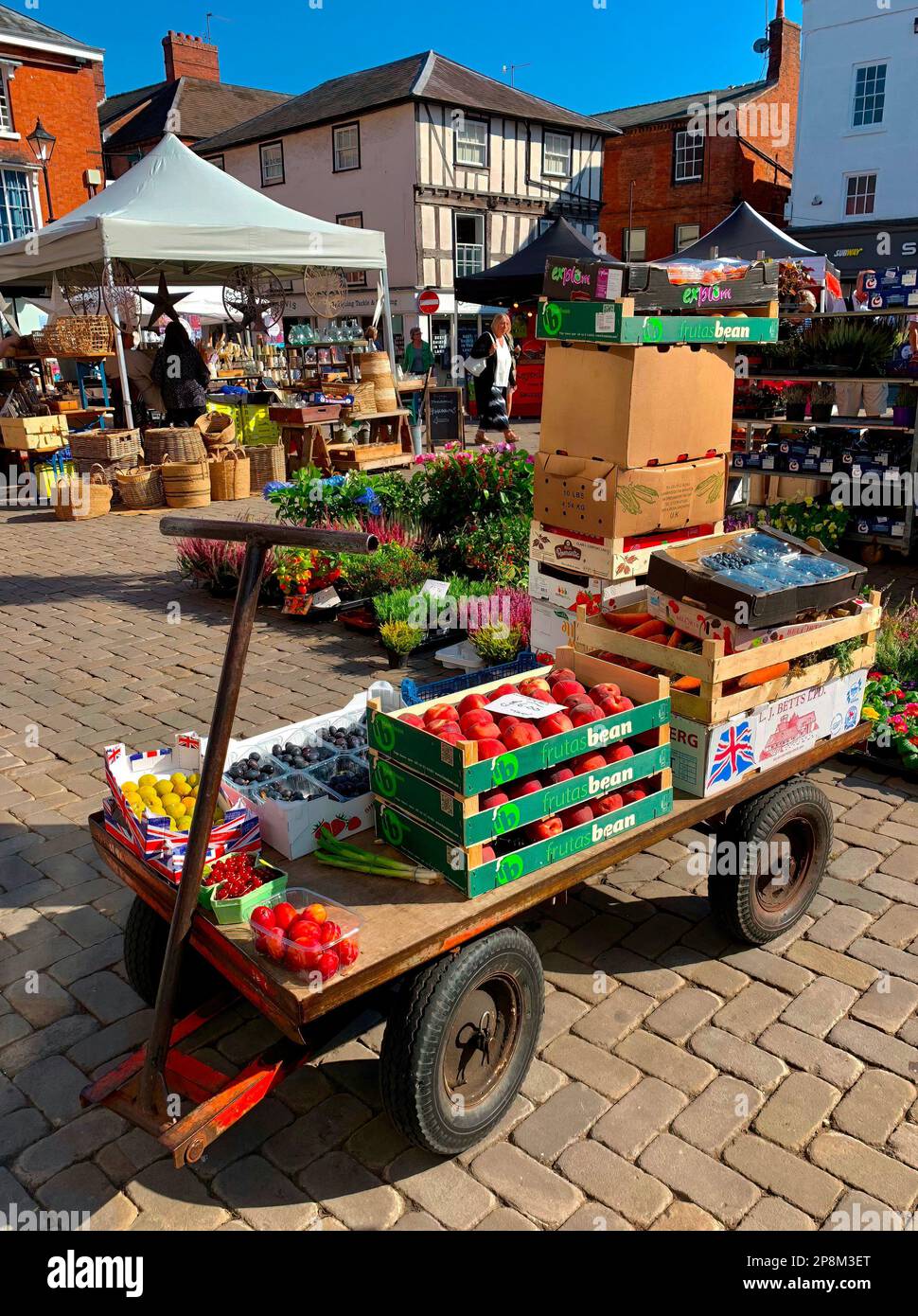 A hand trolley loaded with fresh fruit and vegetables at an outdoor ...