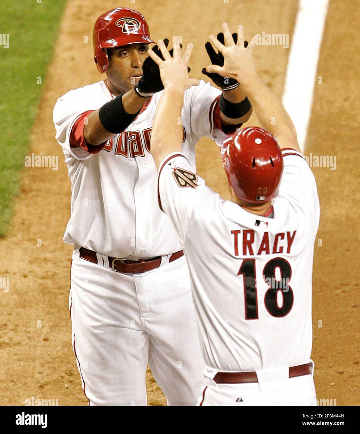 Arizona Diamondbacks' Tony Clark high fives teammate Chad Tracy (18 ...