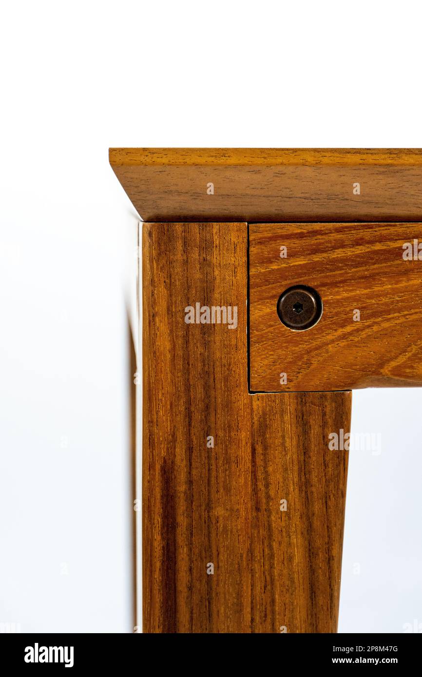 A vertical shot of a rectangular wooden table detail isolated in a ...
