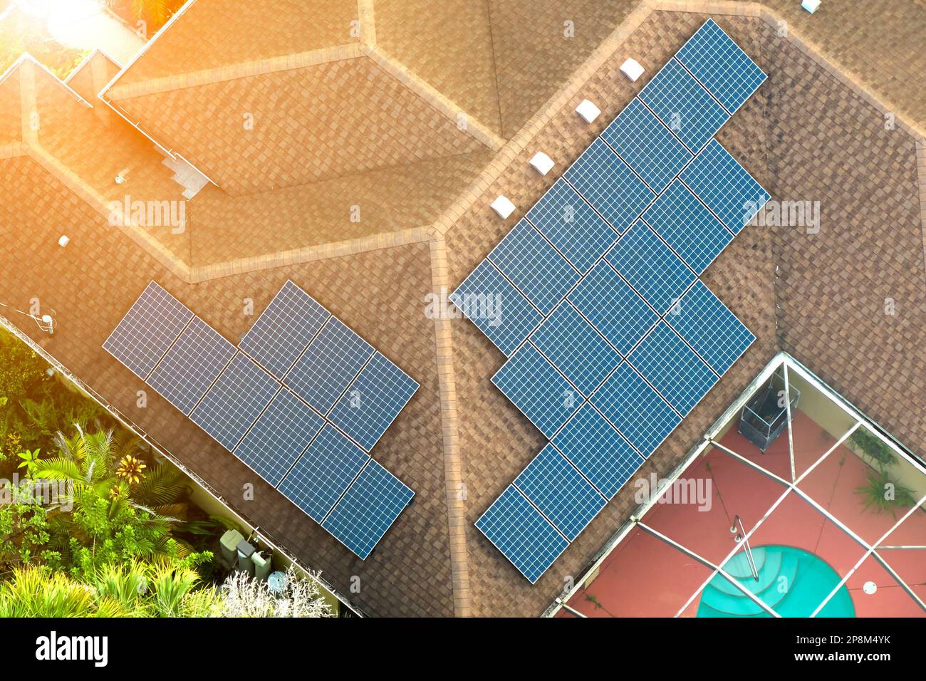 Aerial view of regular american home roof with blue solar photovoltaic ...