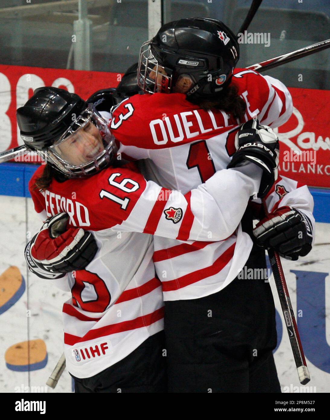 Team Canada's Jayna Hefford (left) and Caroline Ouellette, centre, hug ...