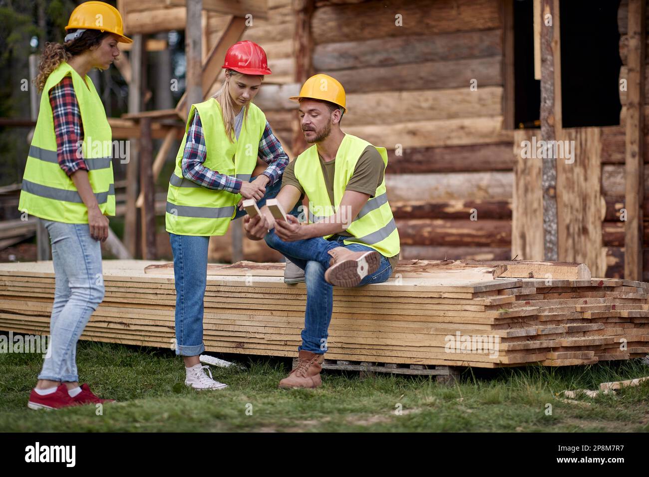 young construction workers working on wooden house construct Stock ...