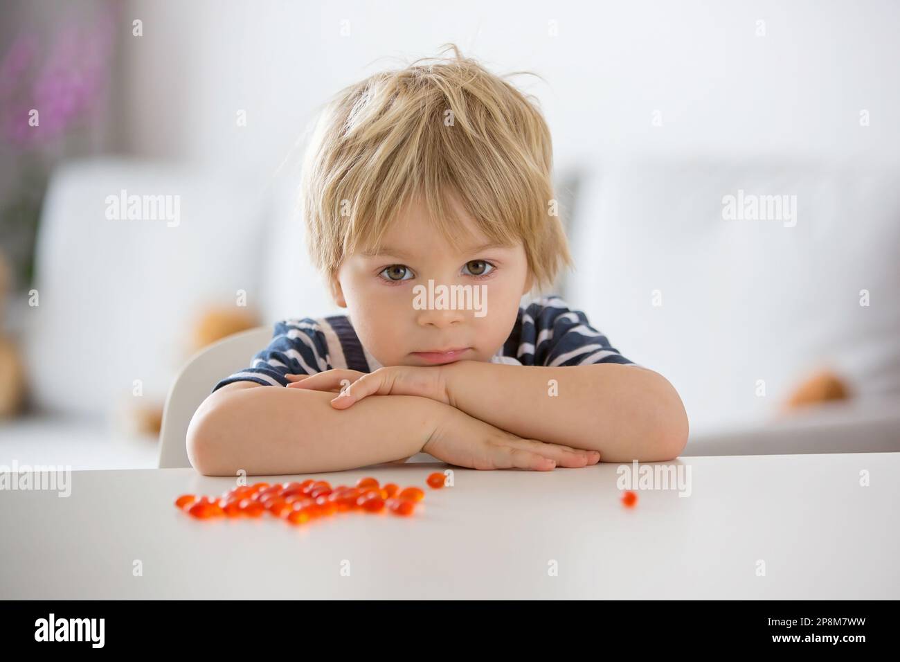 Cute little child, toddler boy, eating alfa omega 3 child supplement ...