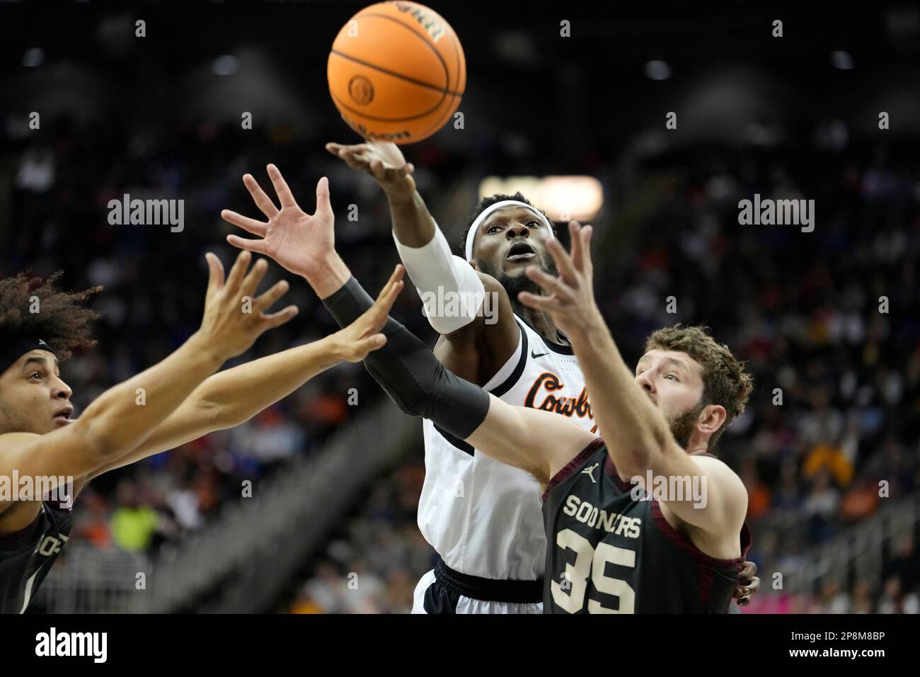 MAR 08 2023: Oklahoma State forward Moussa Cisse (33), Oklahoma forward ...