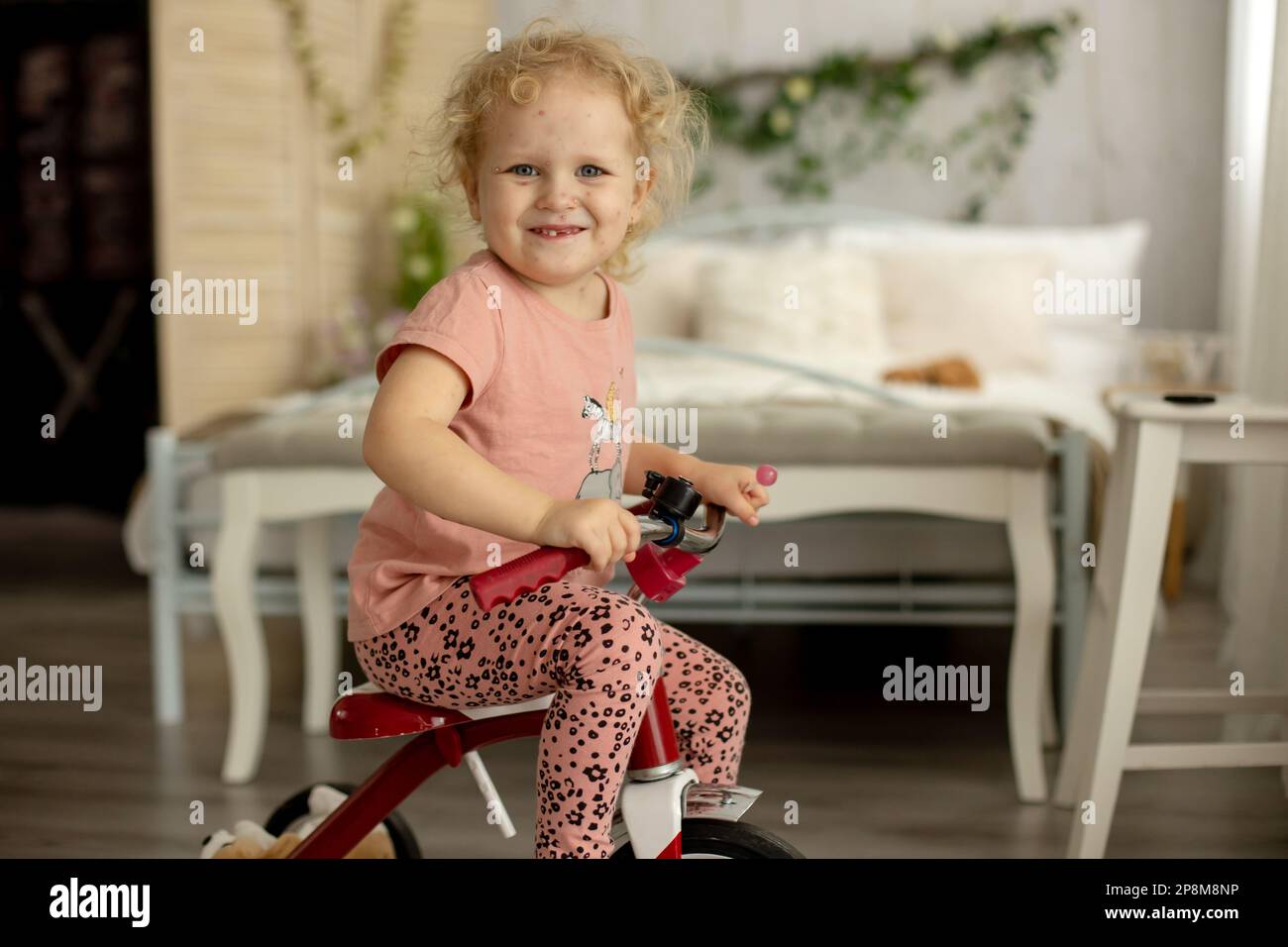 Little toddler girl with chickenpox in bed, playing at home, quarantine ...