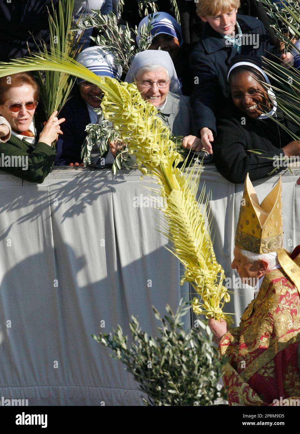 Pope Benedict XVI, bottom right, holds a woven palm frond as he arrives ...