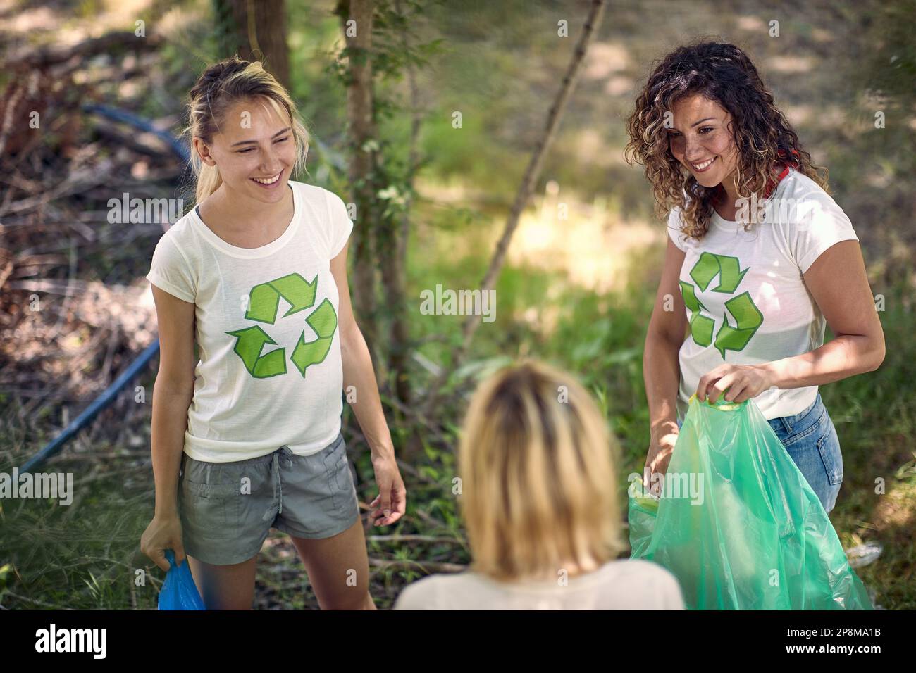 Women collecting waste in forest hi-res stock photography and images ...