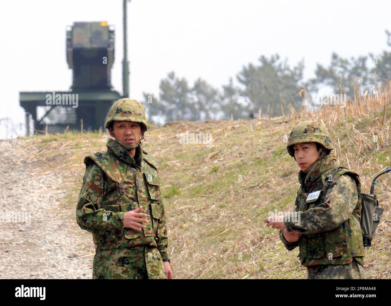 Japan Self-Defense Force soldiers confer each other near the deployed ...