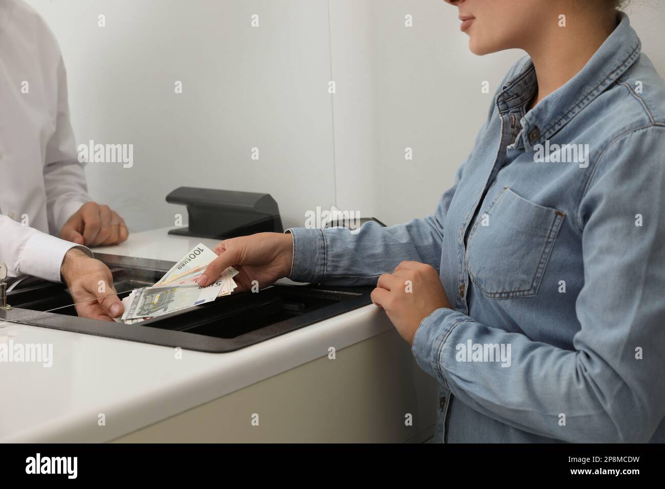 Woman giving money to cashier in bank, closeup. Currency exchange Stock ...