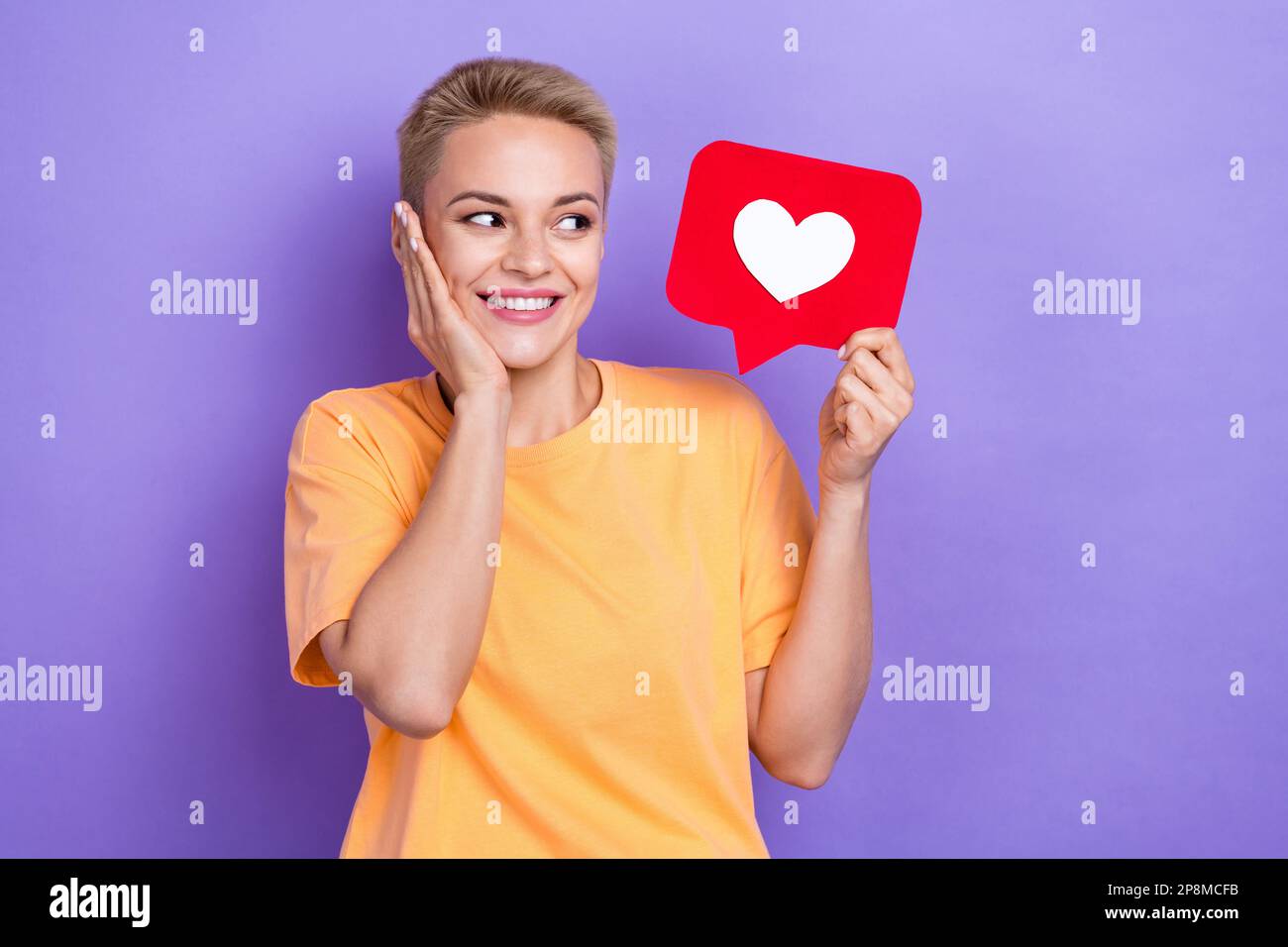 Portrait of cheerful cute girl hand touch cheek look paper like card ...