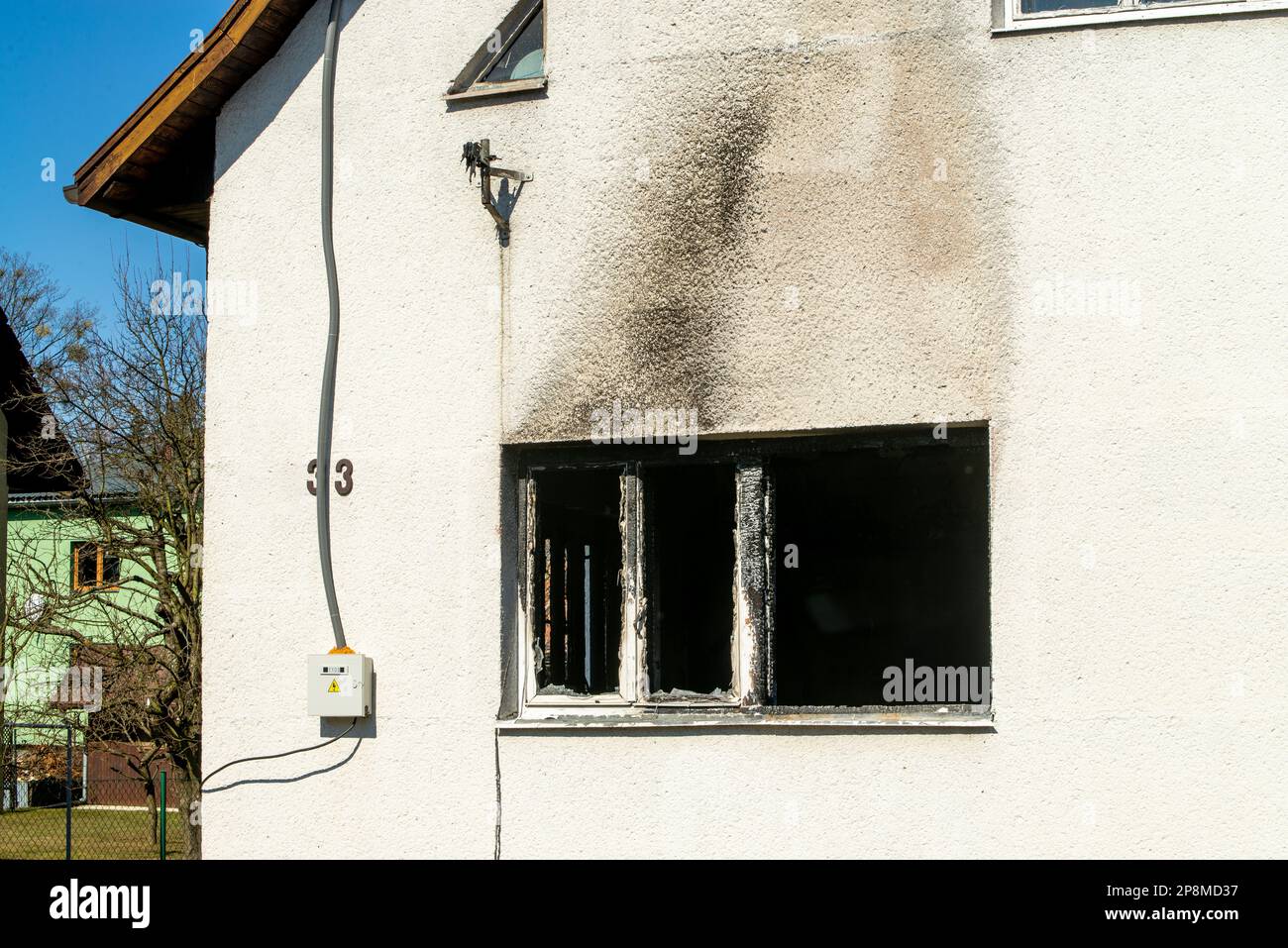 close-up of burnt white family house, window and electricity detail ...