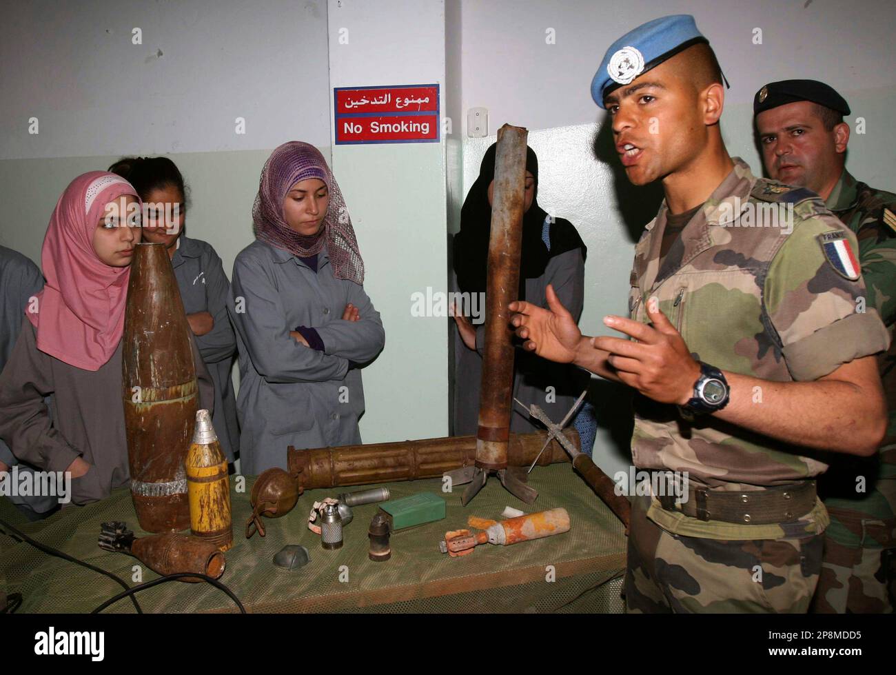 A French UN peacekeeper, right, shows cluster bombs and munitions to ...