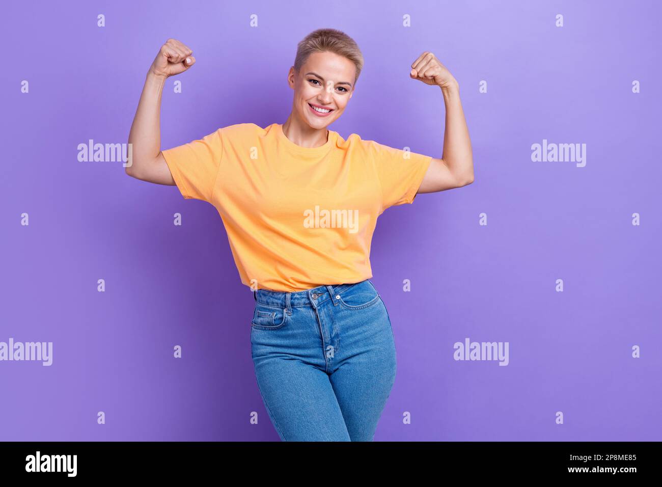 Photo of positive attractive young girl raise fists up showing strong ...