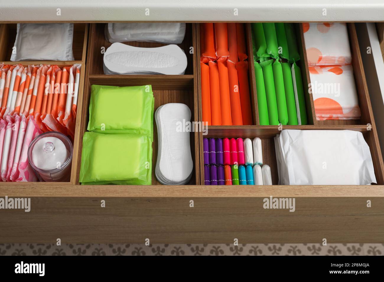 Storage of different feminine hygiene products in wooden drawer, above ...