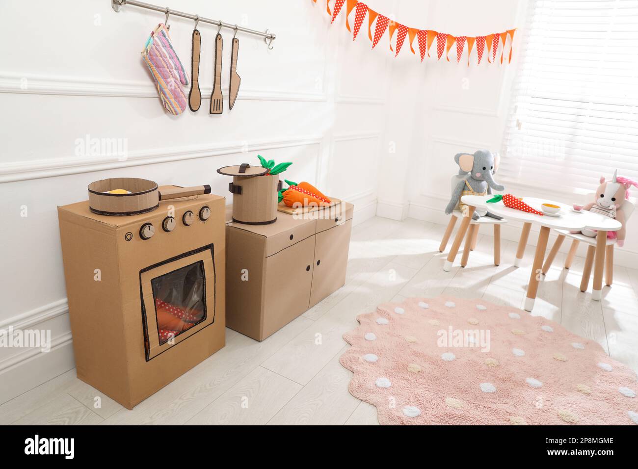 Toy cardboard kitchen with stove and utensils at home Stock Photo - Alamy