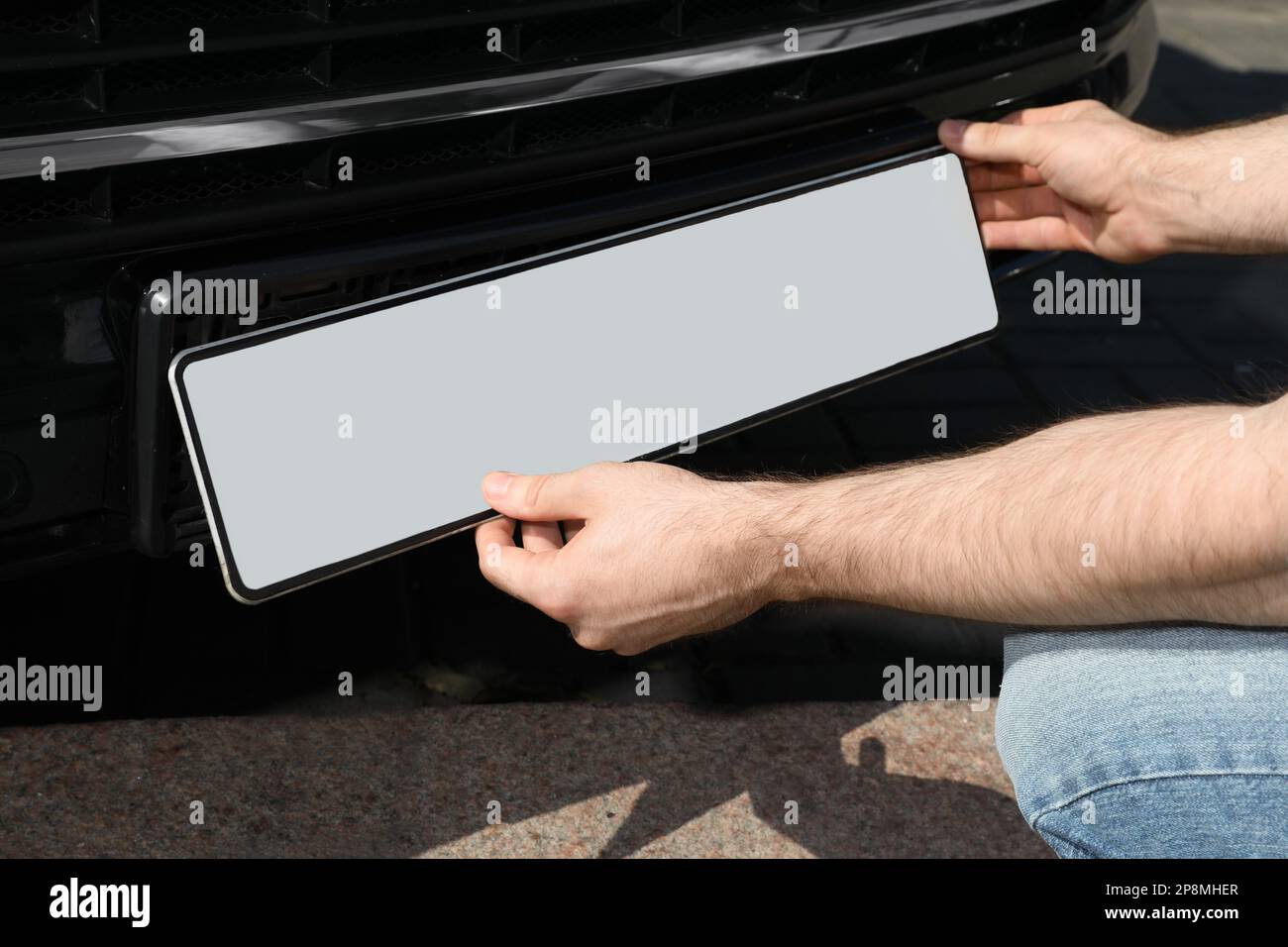 Man installing vehicle registration plate outdoors, closeup Stock Photo ...