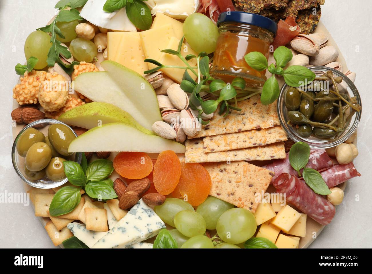 Different tasty appetizers on light table, top view Stock Photo - Alamy