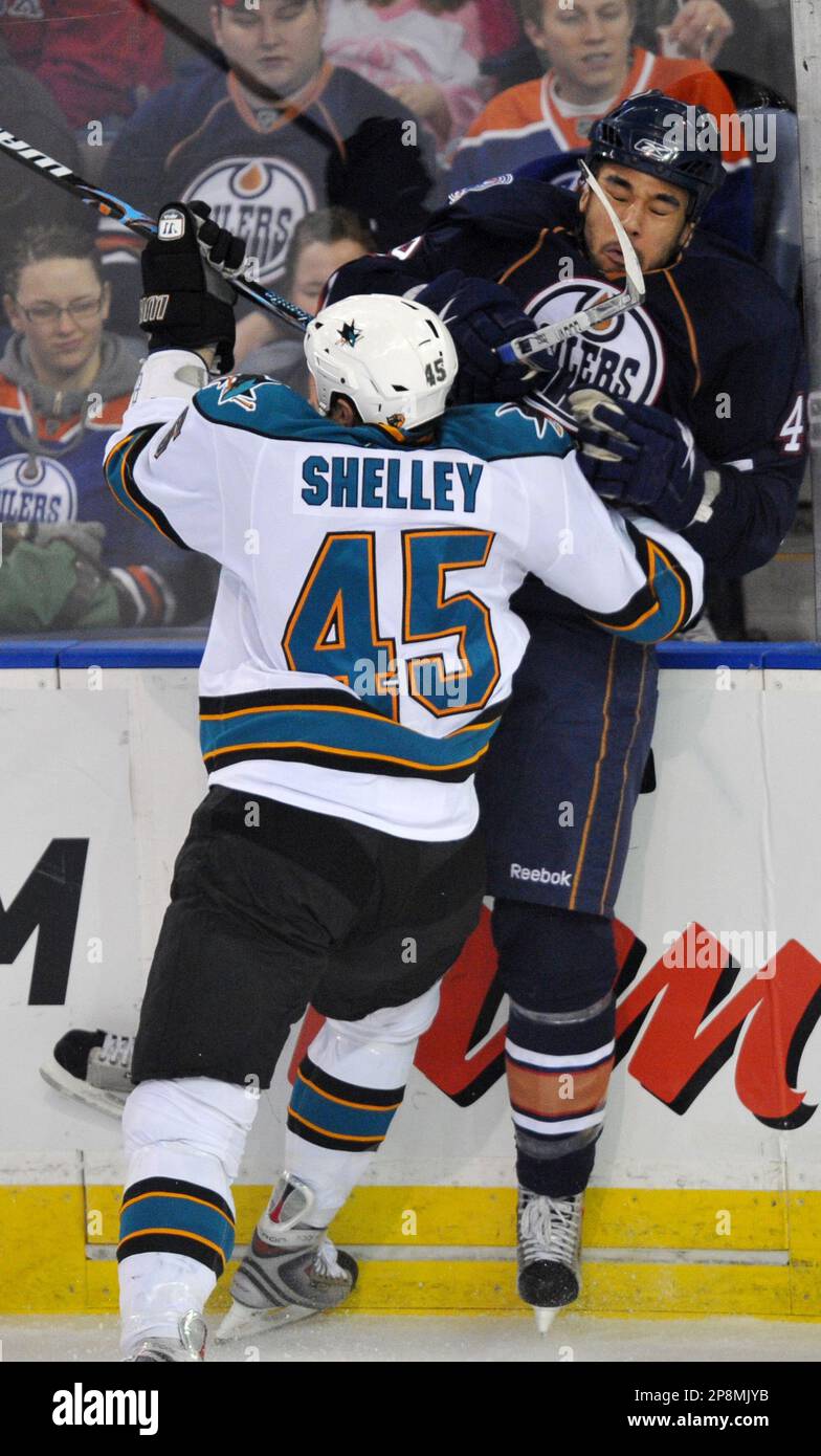 The Edmonton Oilers' Zack Stortini, right, is checked by San Jose ...