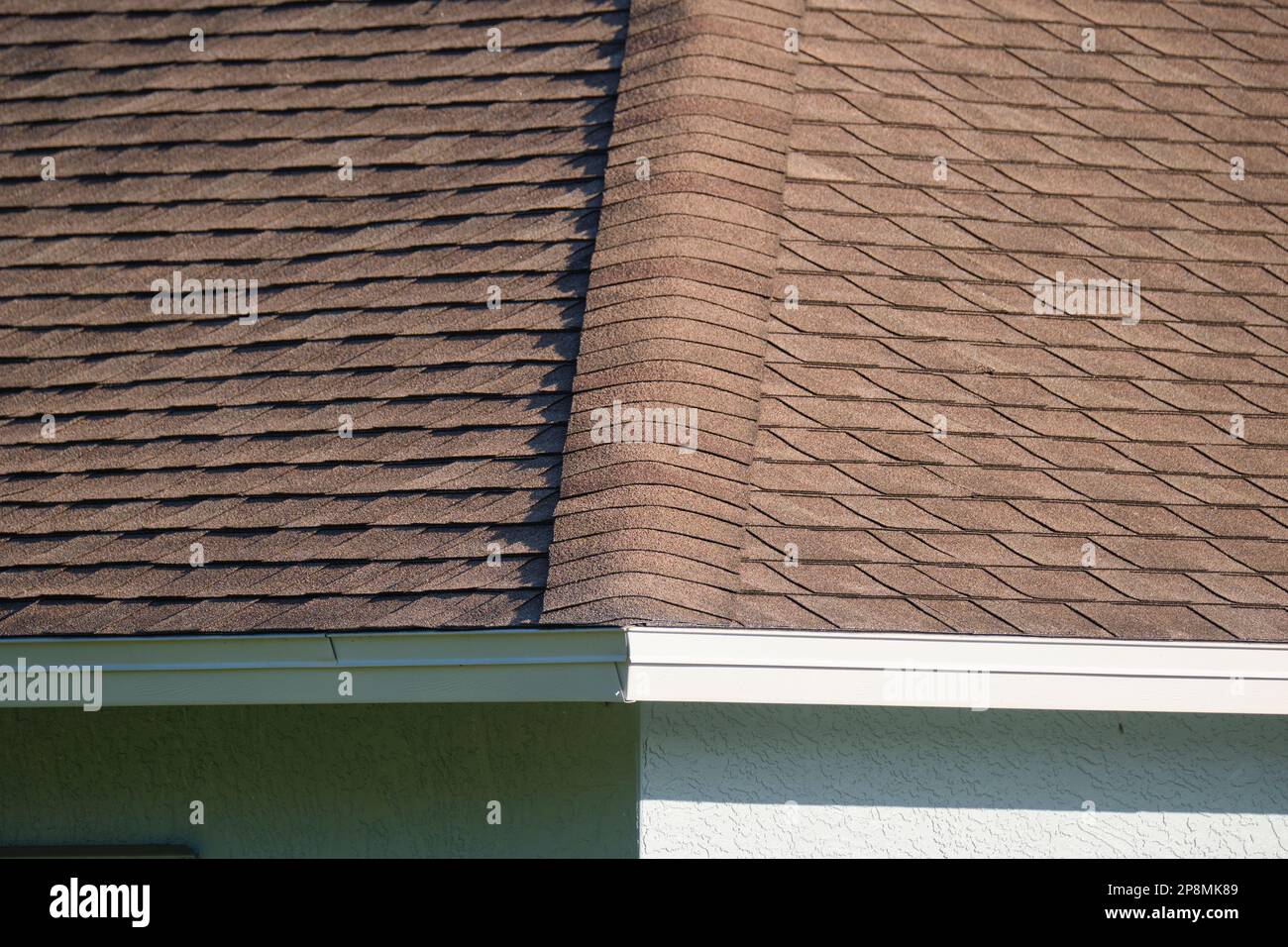 Closeup of house roof top covered with asphalt or bitumen shingles ...