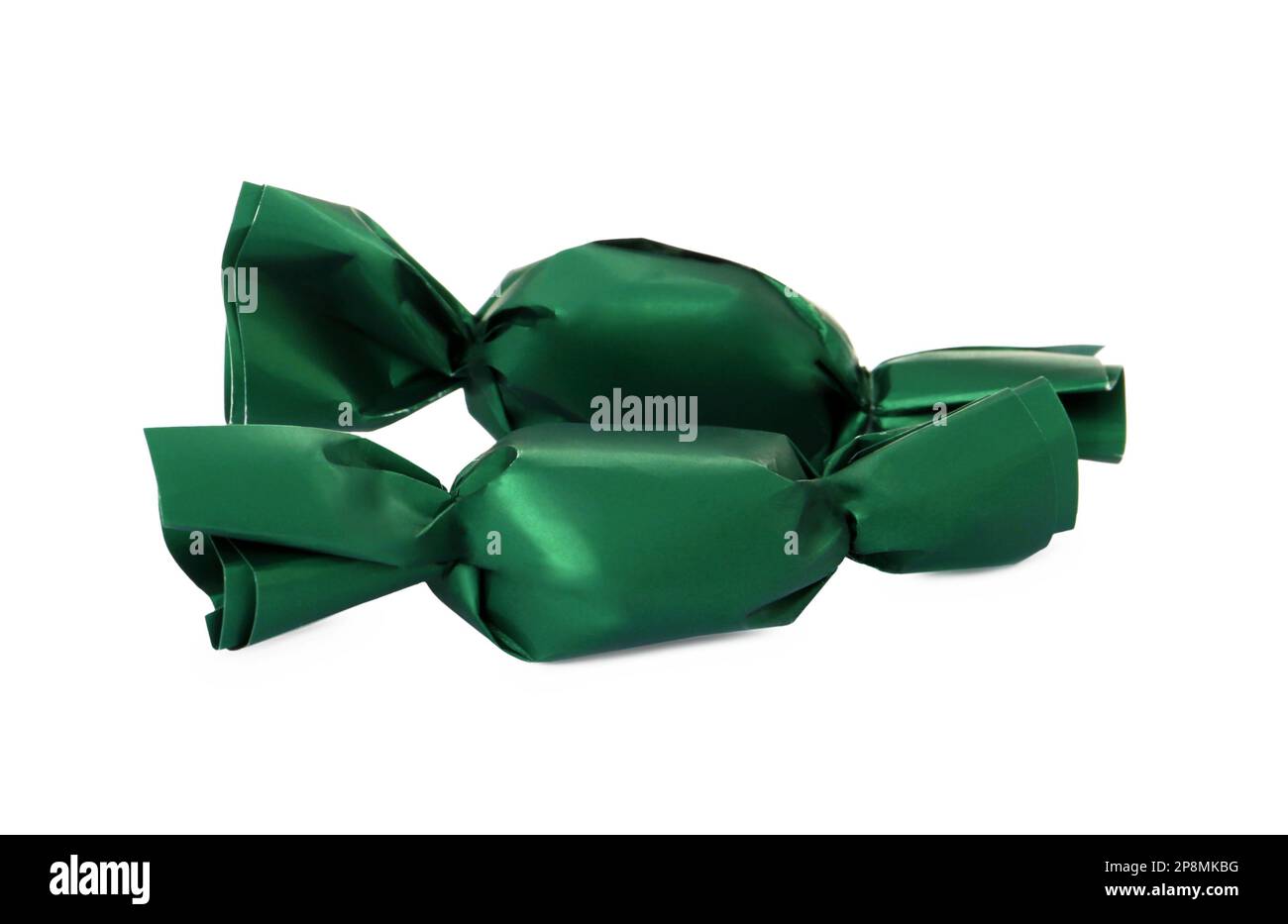 Delicious candies in dark green wrappers on white background Stock ...