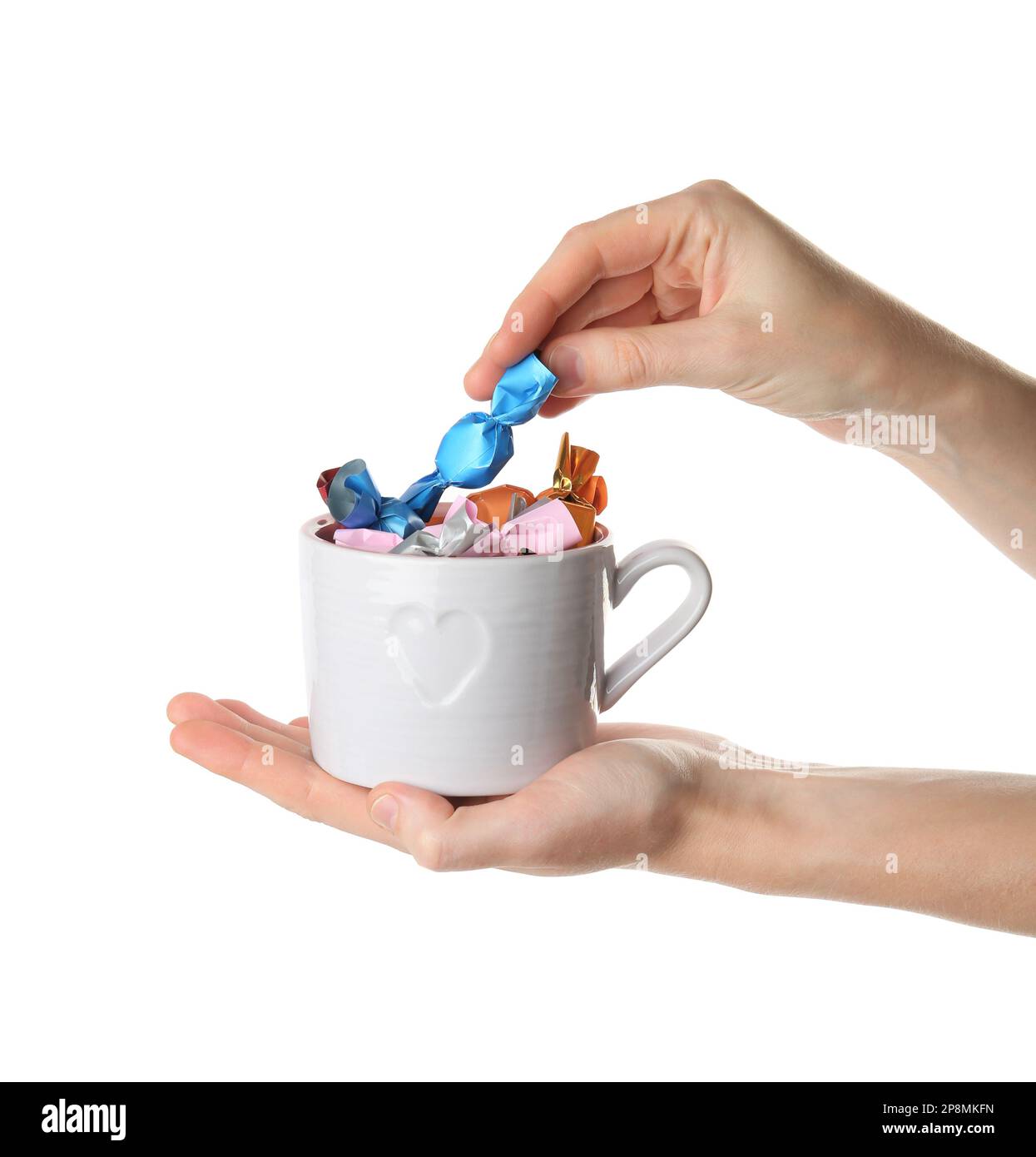 Woman taking candy in light blue wrapper from cup isolated on white ...