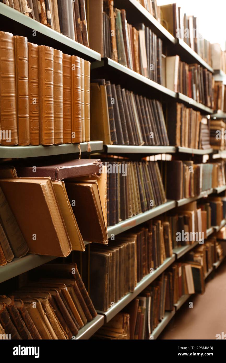 Collection of different books on shelves in library Stock Photo - Alamy