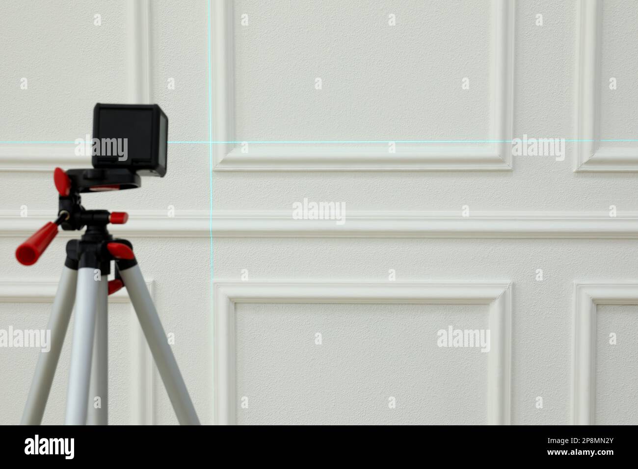 Cross lines of laser level on white wall Stock Photo - Alamy