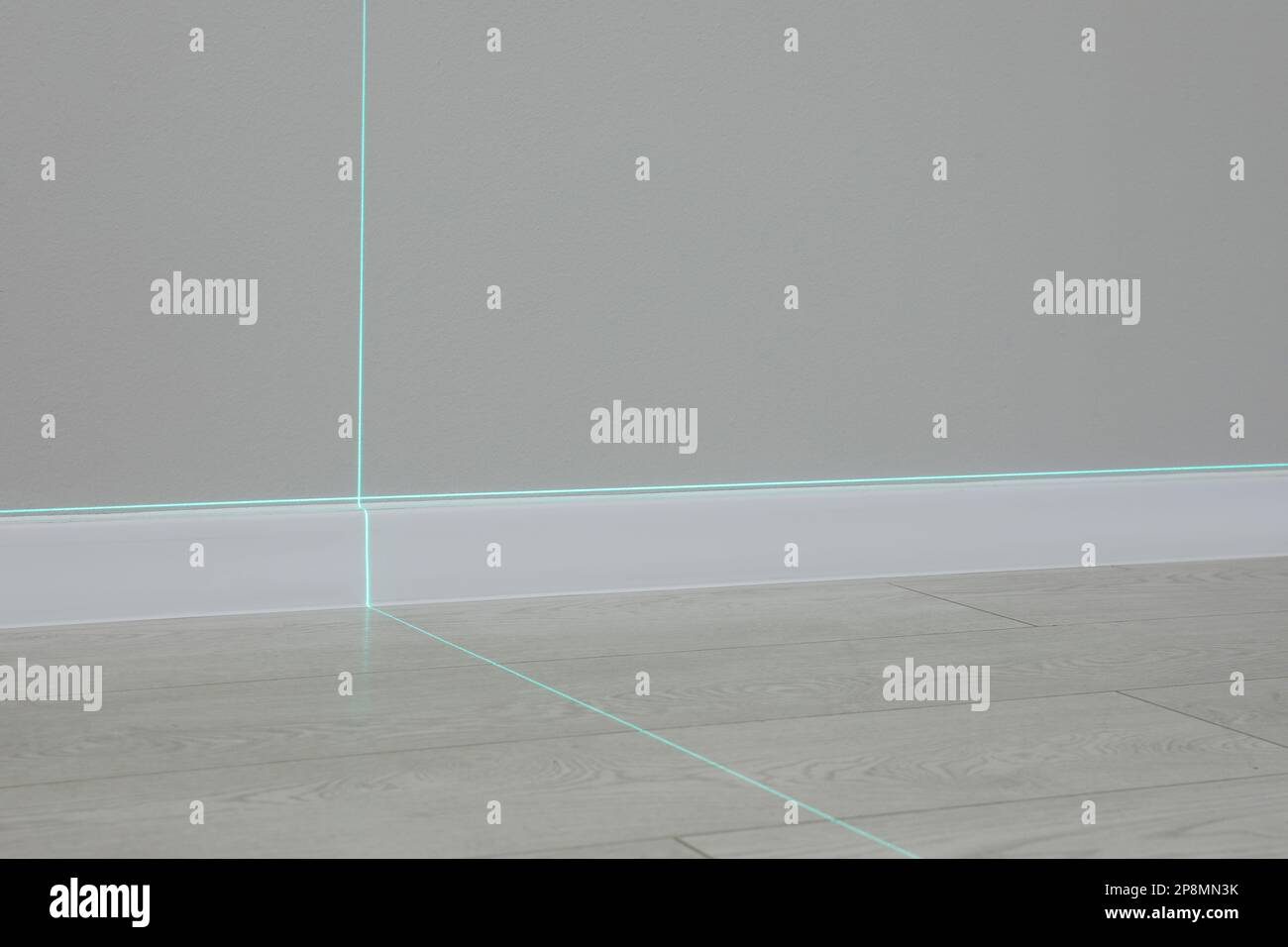 Cross lines of laser level on wall and floor indoors Stock Photo - Alamy