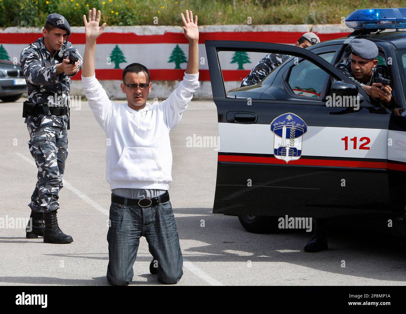 Lebanese policemen demonstrate how to arrest a criminal during the ...