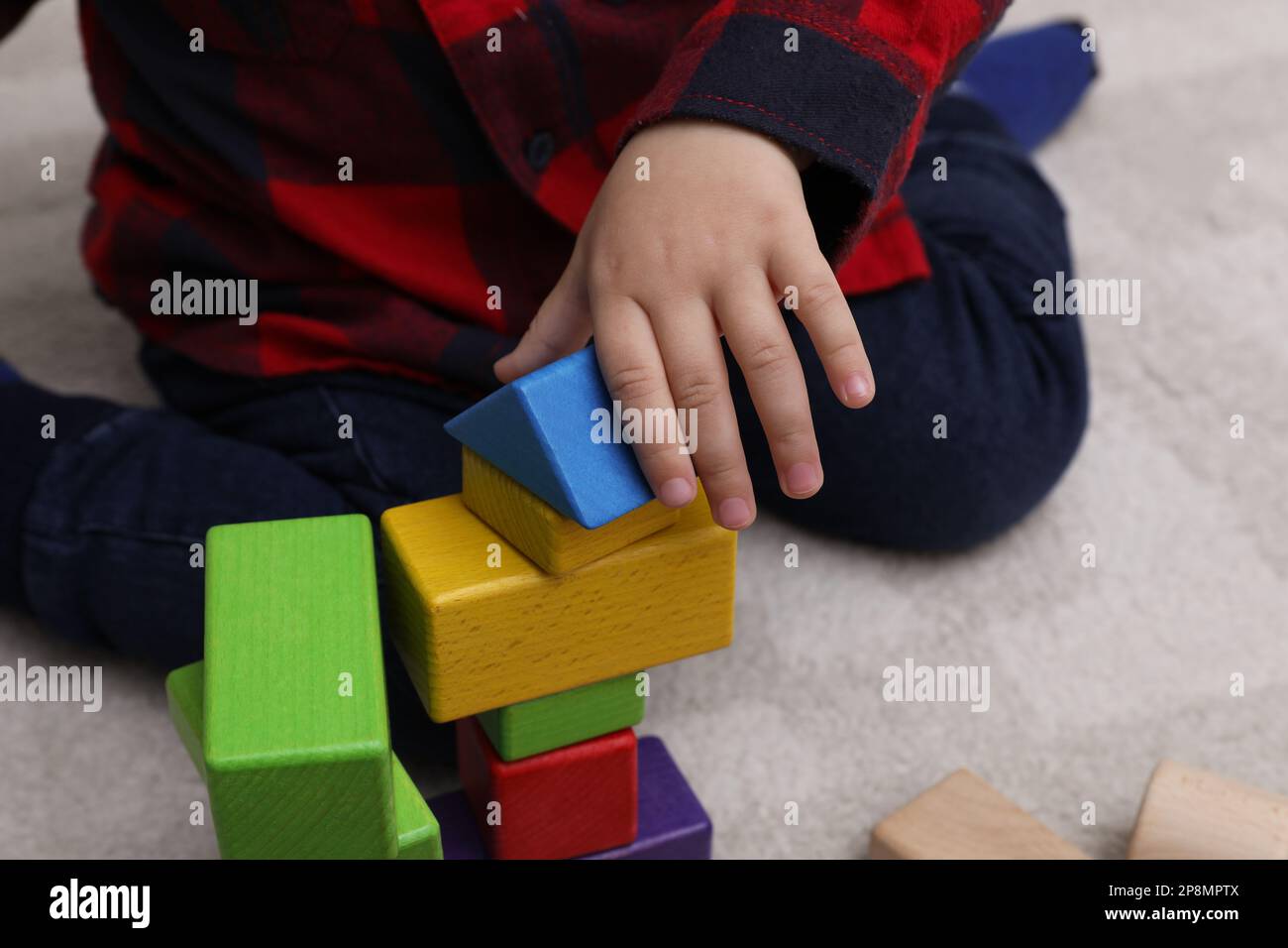 Little child playing with building blocks on carpet, closeup Stock ...