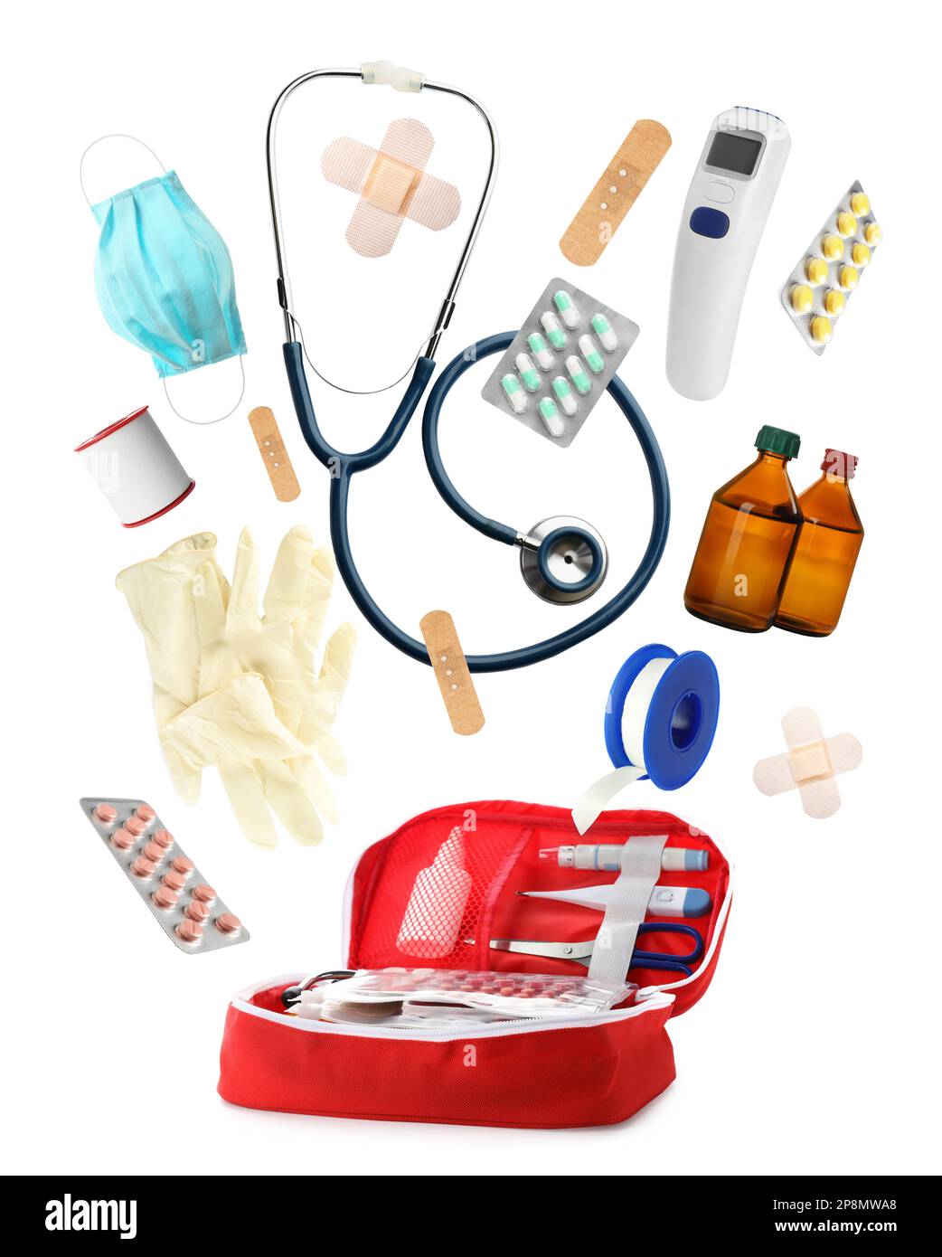 First aid kit. Different medical supplies falling on white background ...