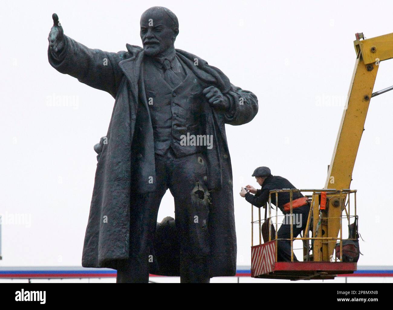 An investigator takes pictures of one of Russia's best-known statues of ...
