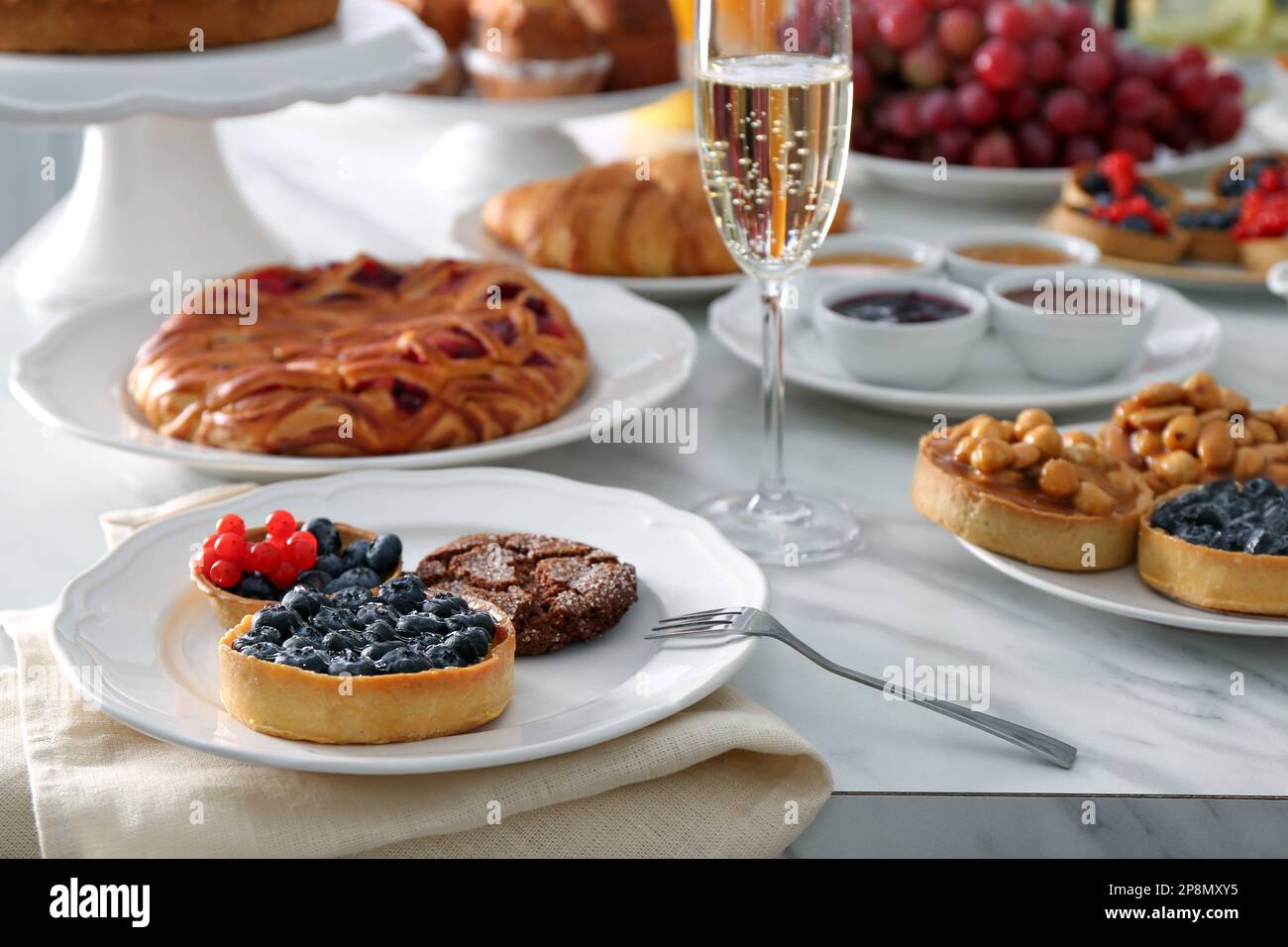 Variety of snacks on white marble table in buffet style Stock Photo - Alamy