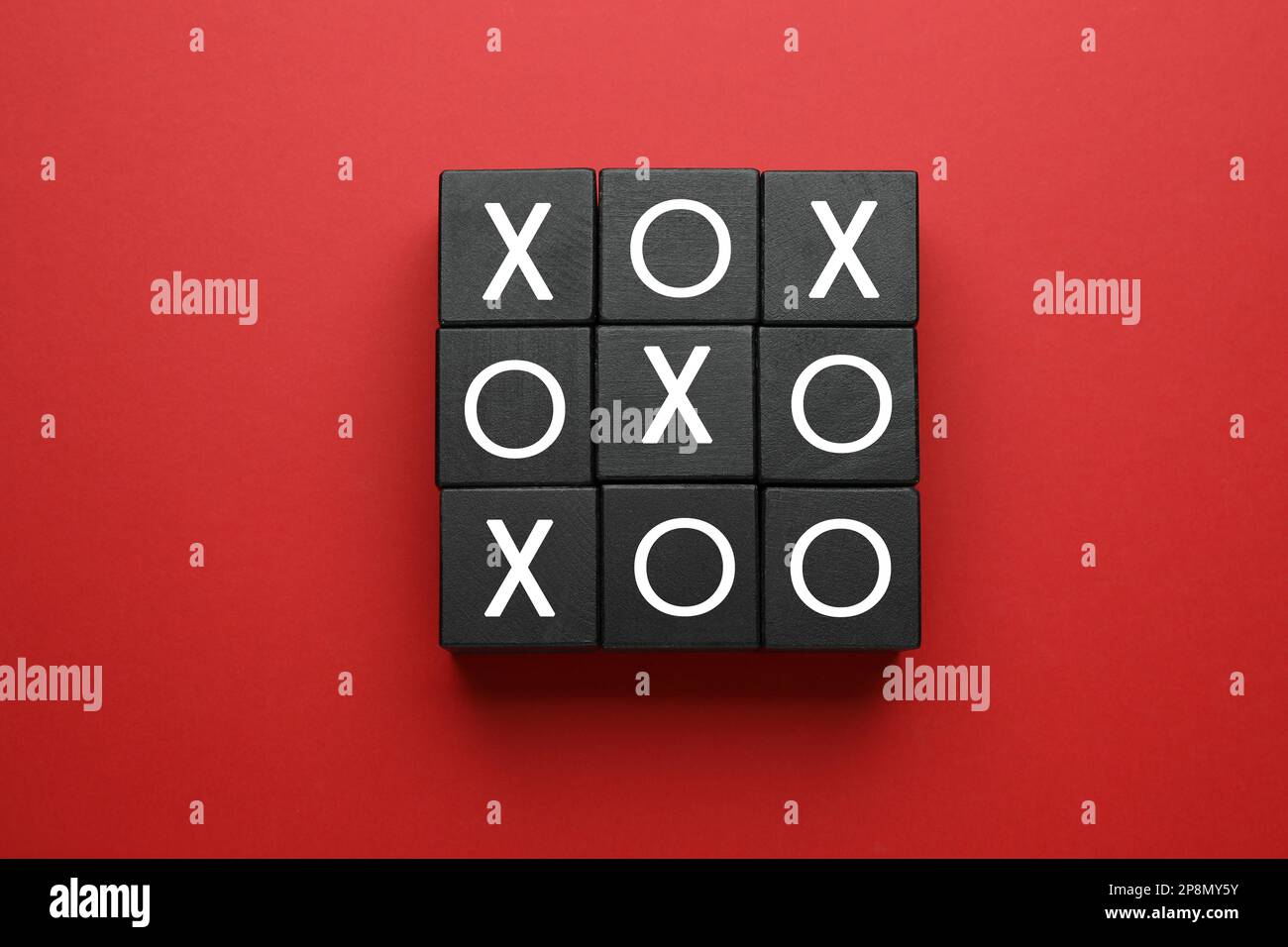 Tic tac toe cube set on red background, flat lay Stock Photo - Alamy