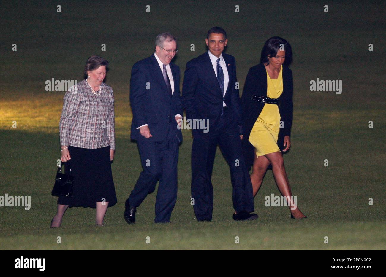 President Barack Obama and first lady Michelle Obama walk with Charge d ...