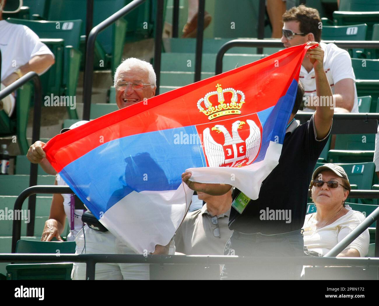 Fans of Novak Djokovic, from Serbia, wave their country's flag during ...