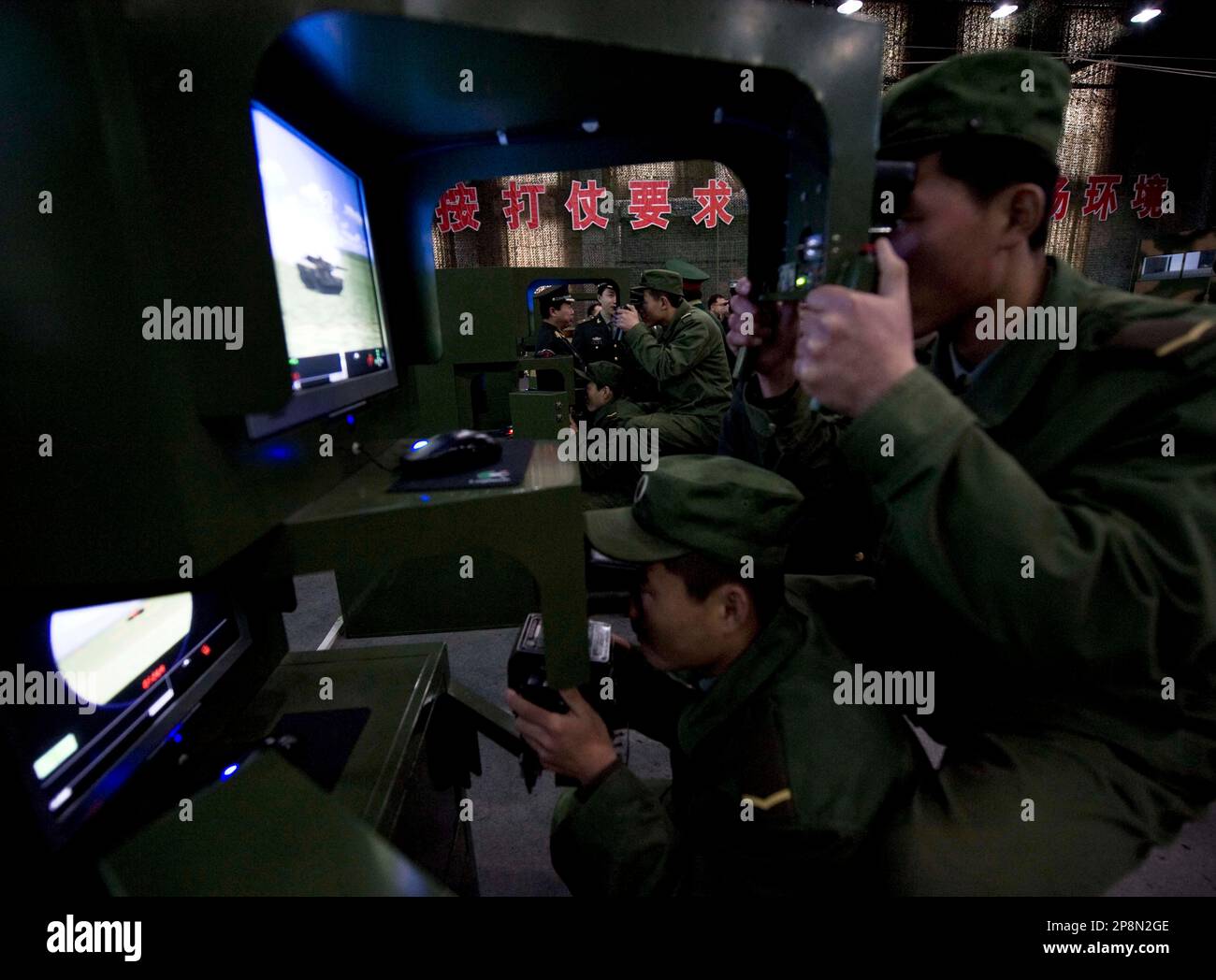 Chinese soldiers try out a 3D simulation battle tank training at the ...