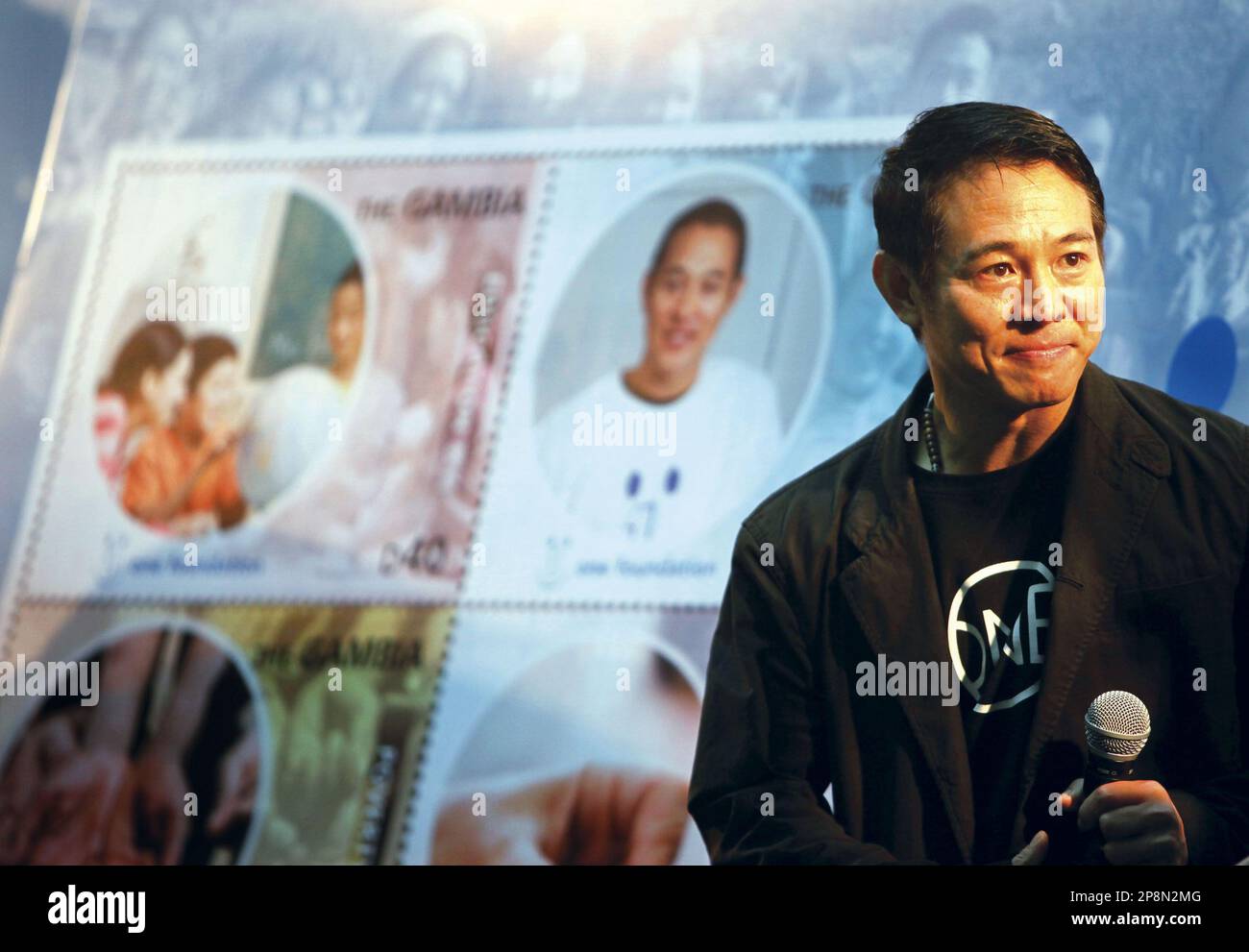 Chinese film actor Jet Li poses next to the samples at launching ...