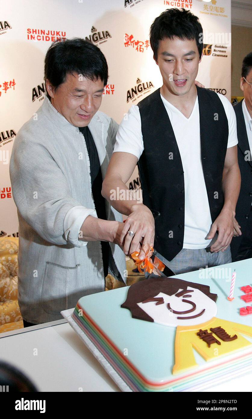 Hong Kong actors Jackie Chan, left, and Daniel Wu cut a cake to ...