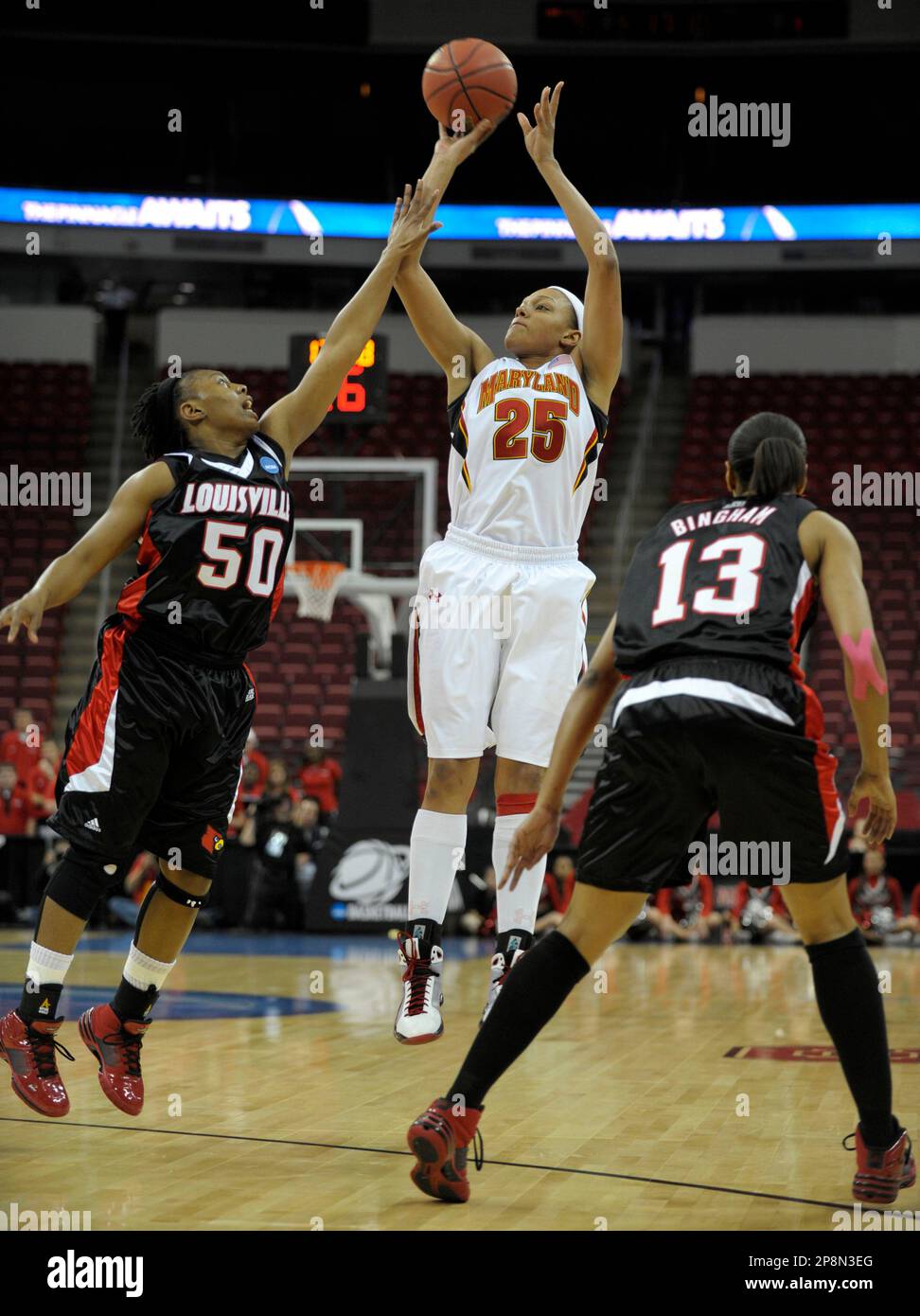 Louisville's Deseree' Byrd (50) and Candyce Bingham (13) defend as ...