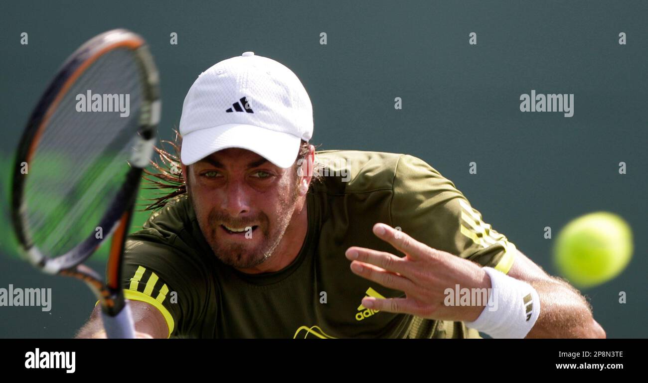 Nicolas Massu, of Chile, returns the ball to Andy Murray, of Britain ...