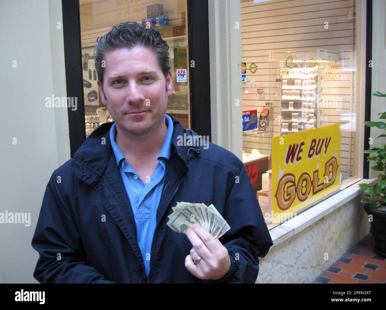 Actor Scott Alan Tindell shows off the $62 he got for his 18-karat gold ...
