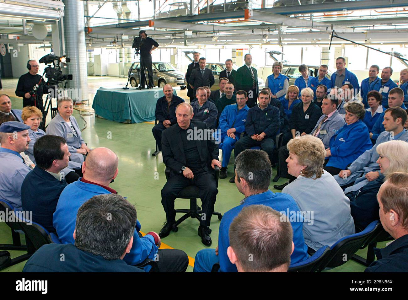 Russian Prime Minister Vladimir Putin, center, meets with workers at ...