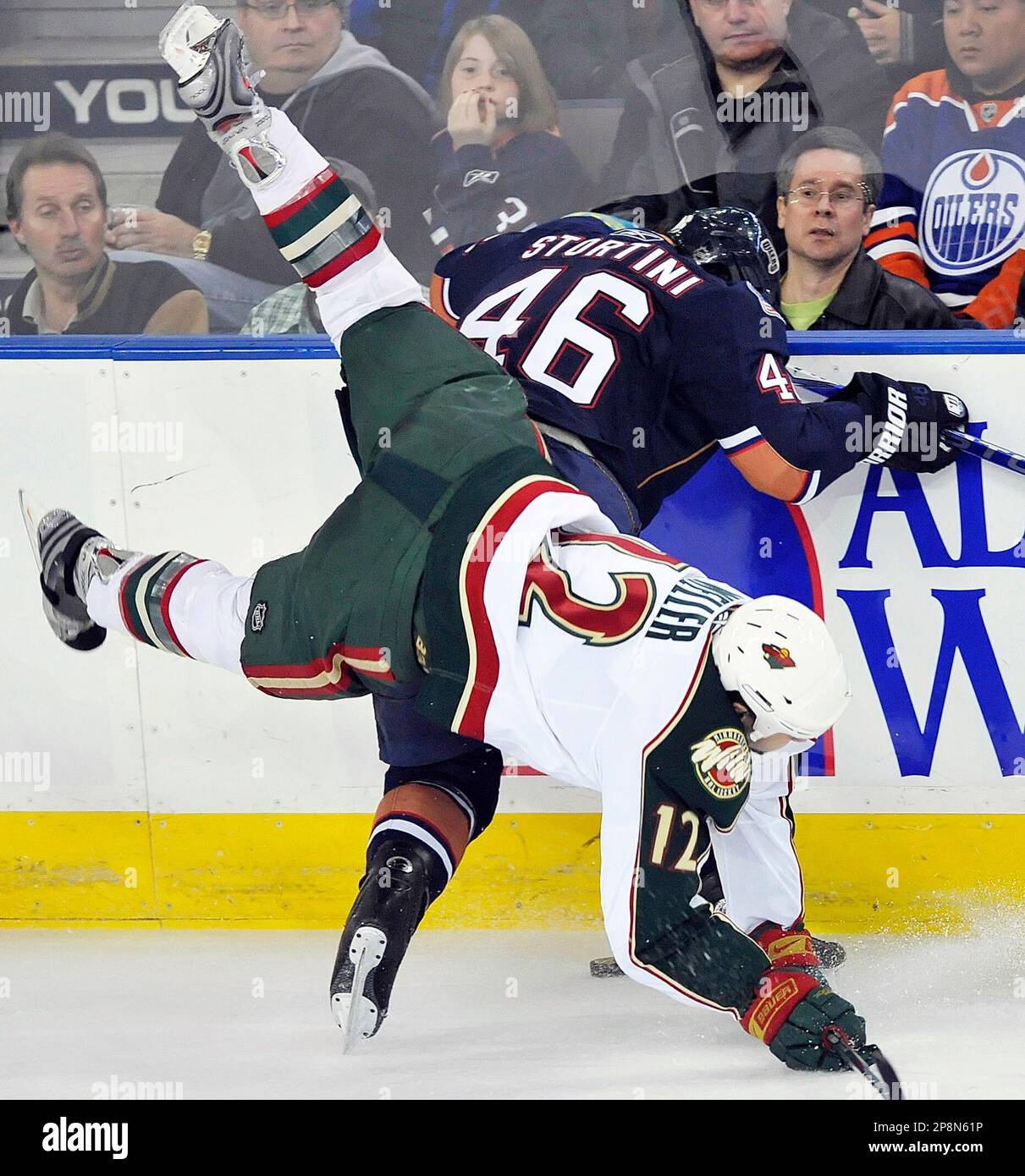 Minnesota Wild defenseman Craig Weller (12) gets checked by Edmonton ...