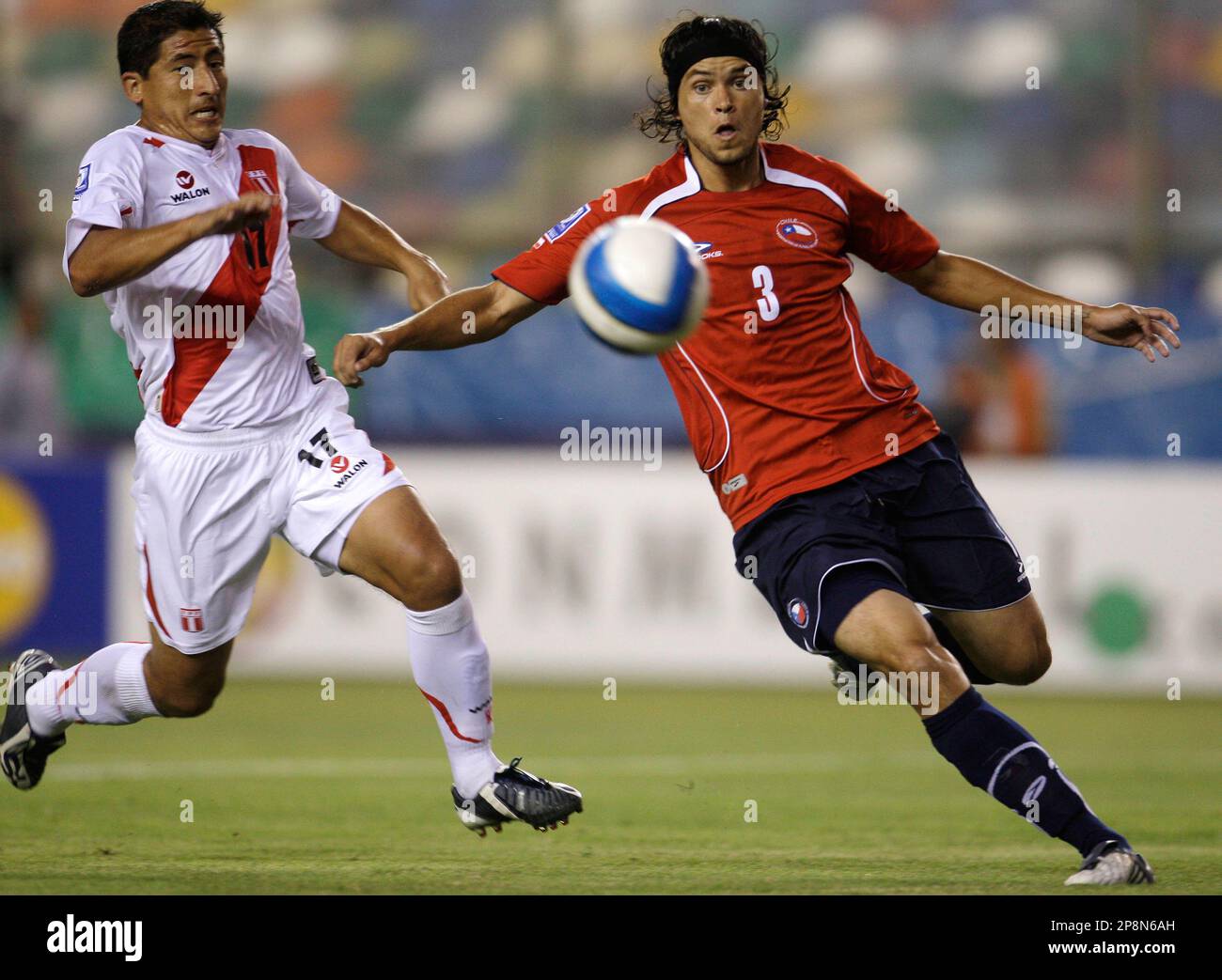 Chile's Waldo Ponce, right, controls the ball under pressure from Peru ...