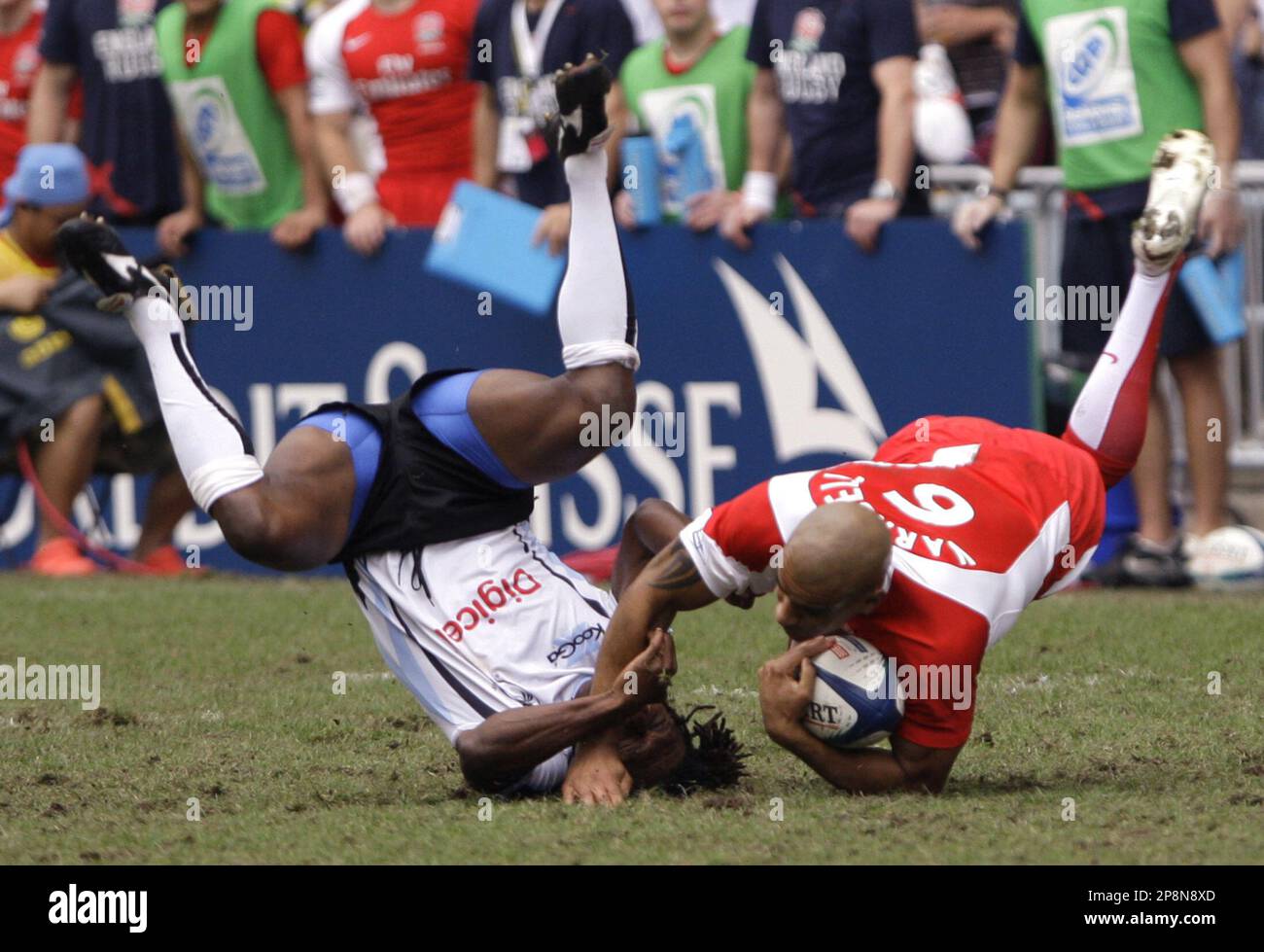 Tom Varndell of England, right, is tackled by Nasoni Roko of Fiji ...